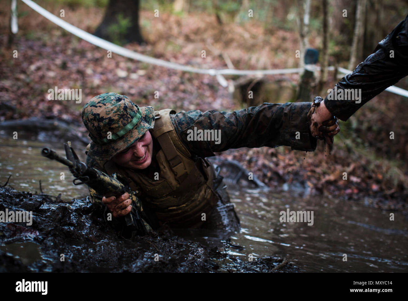Climbing a rope out of mud hi-res stock photography and images - Alamy