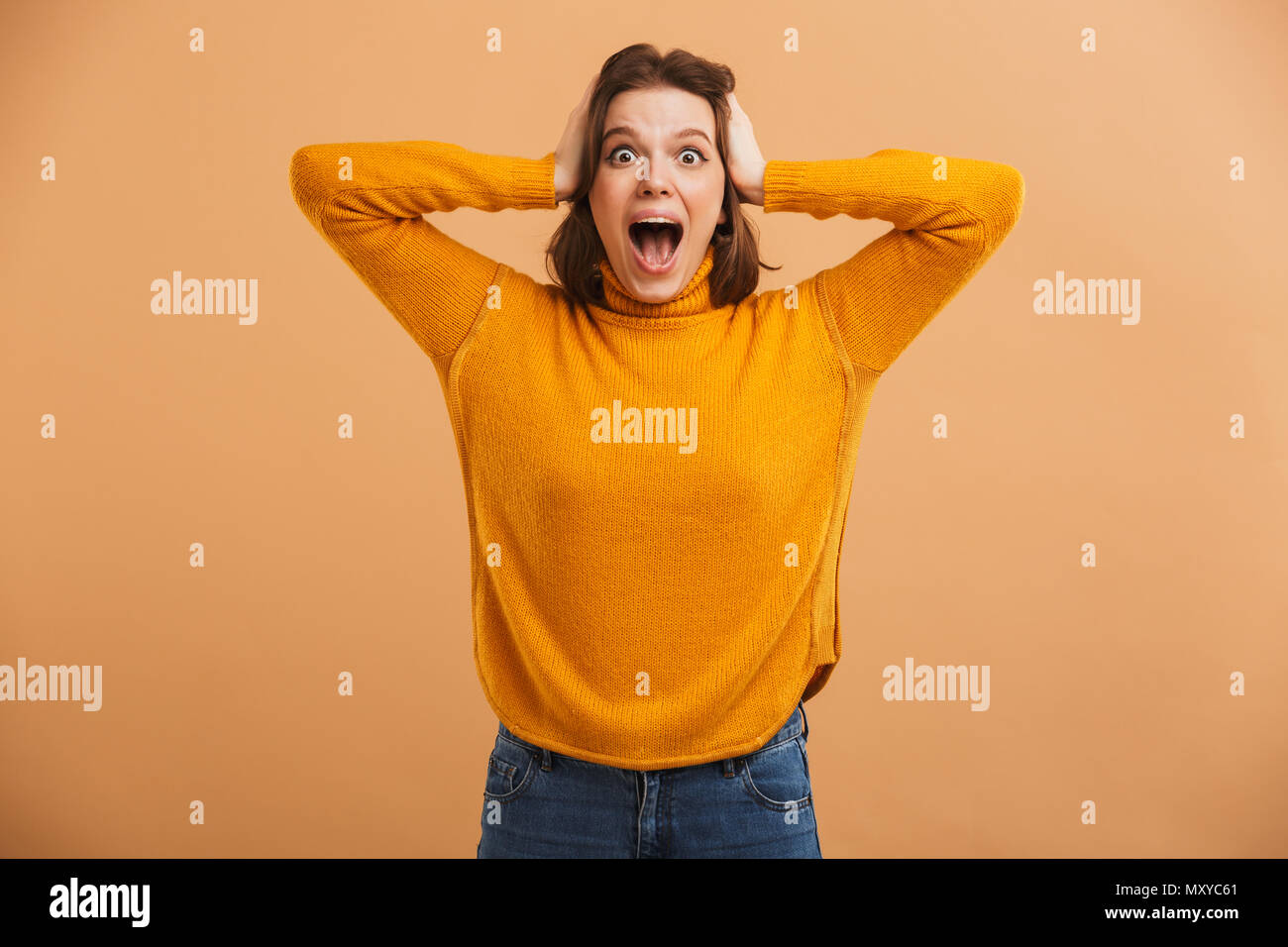 Image of shocked young woman standing isolated looking camera Stock ...