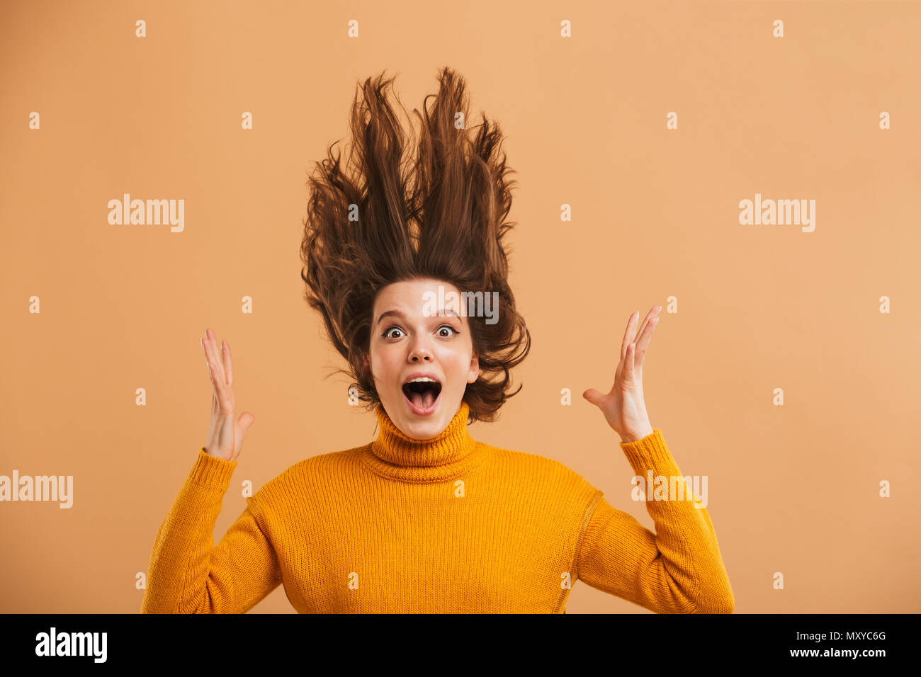 Image of shocked young woman standing isolated looking camera Stock ...