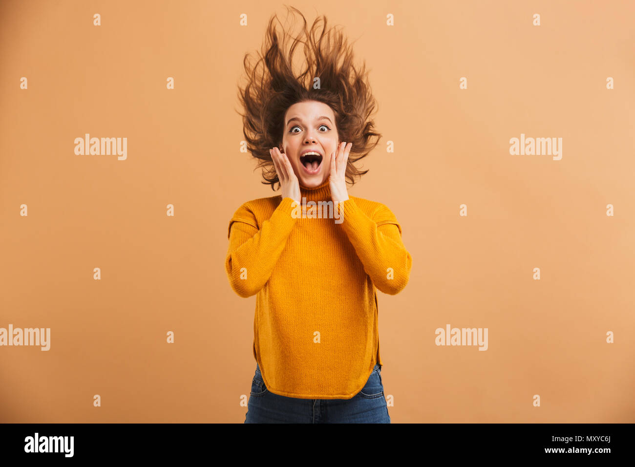 Image of shocked young woman standing isolated looking camera Stock ...
