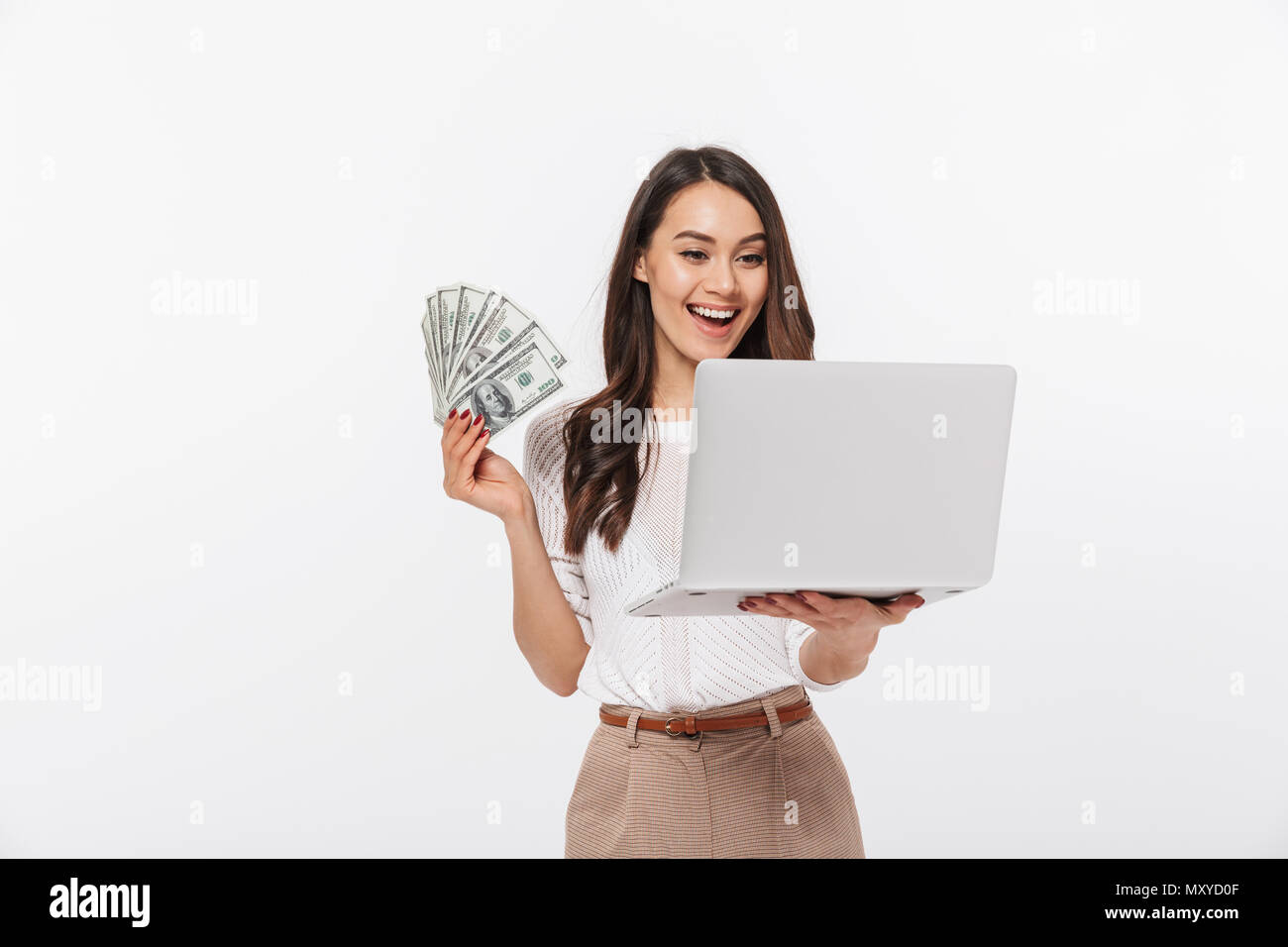 Portrait of a cheerful asian businesswoman showing money banknotes ...