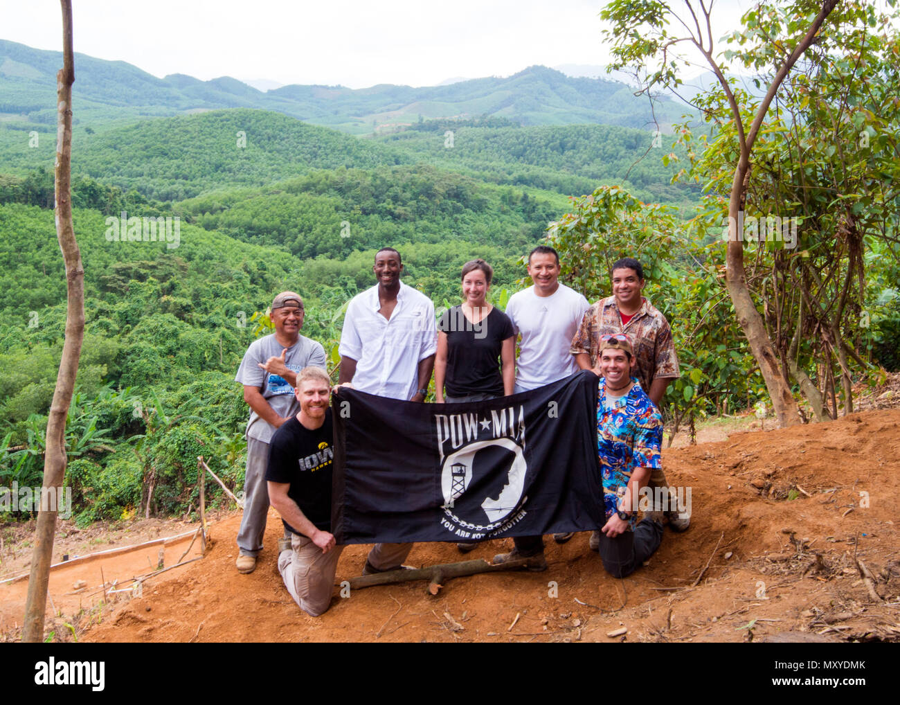 Members of the Defense POW/MIA Accounting Agency (DPAA) pose for a ...