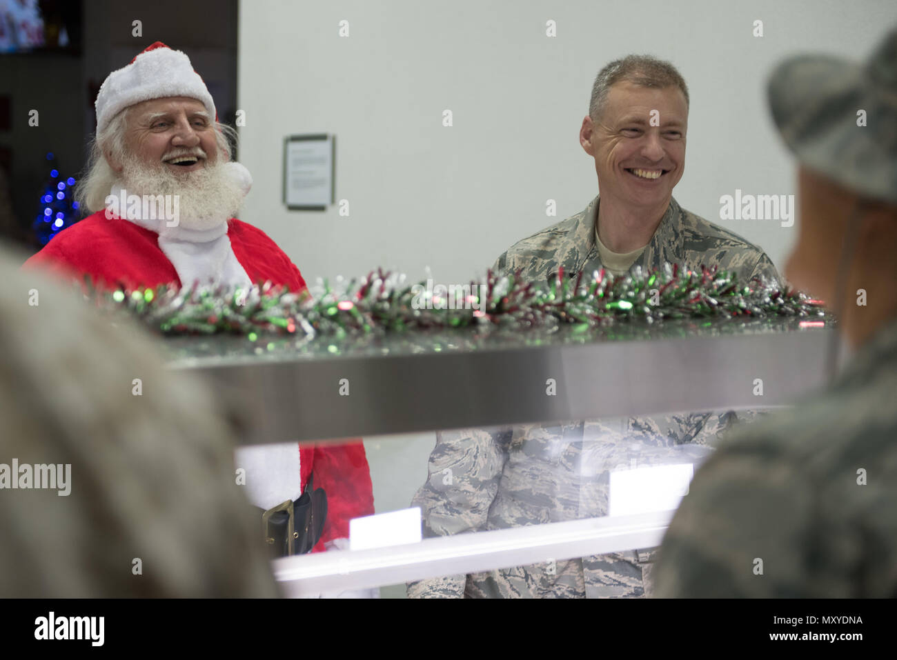 Santa Clause laughs with Senior Master Sgt. Thomas Mattern, 407th ...