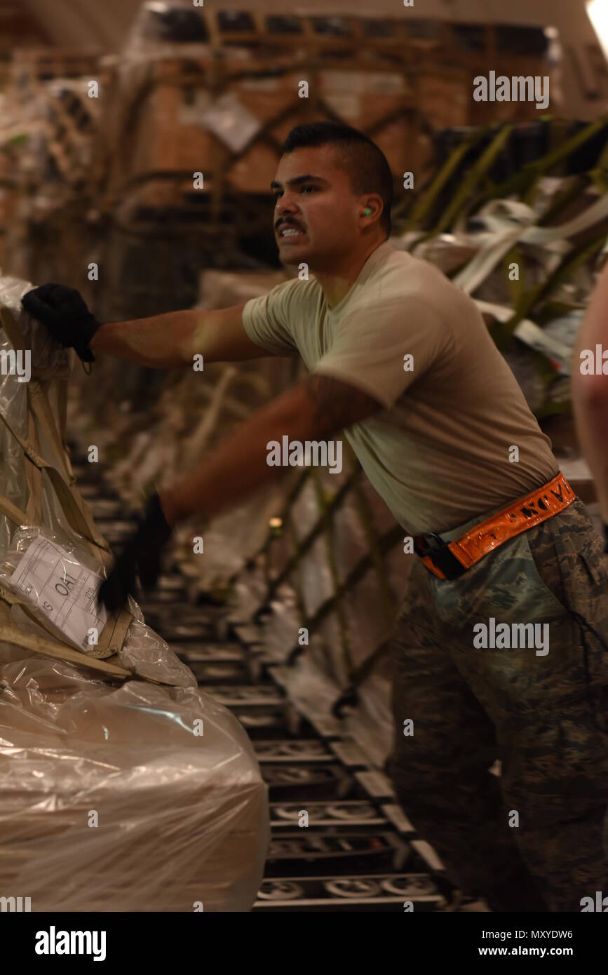 An Airman from the 8th Expeditionary Air Mobility Squadron operates a ...