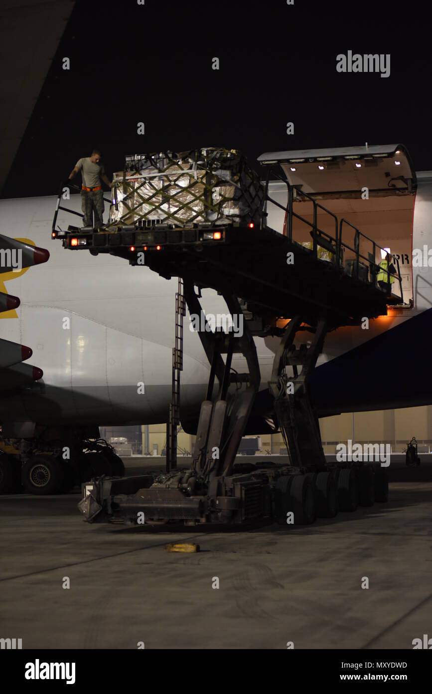 A Tunner 60K cargo loader waits as Airmen with the 8th Expeditionary ...