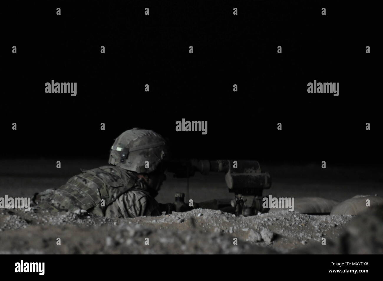 A spotter from a sniper team from the 3rd Armored Brigade Combat Team ...