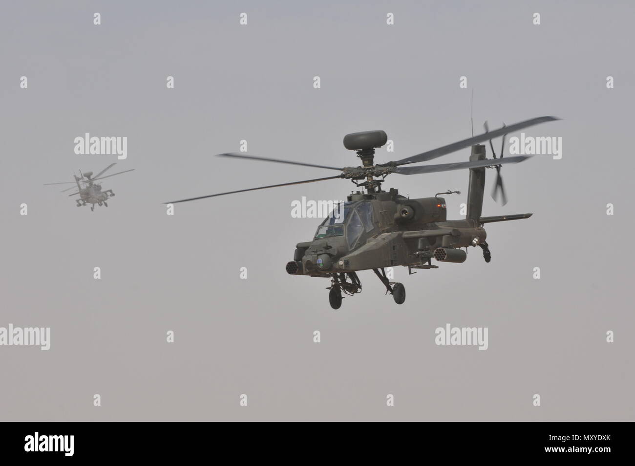 AH-64 Apache Helicopters prepare to engage a target during a joint ...