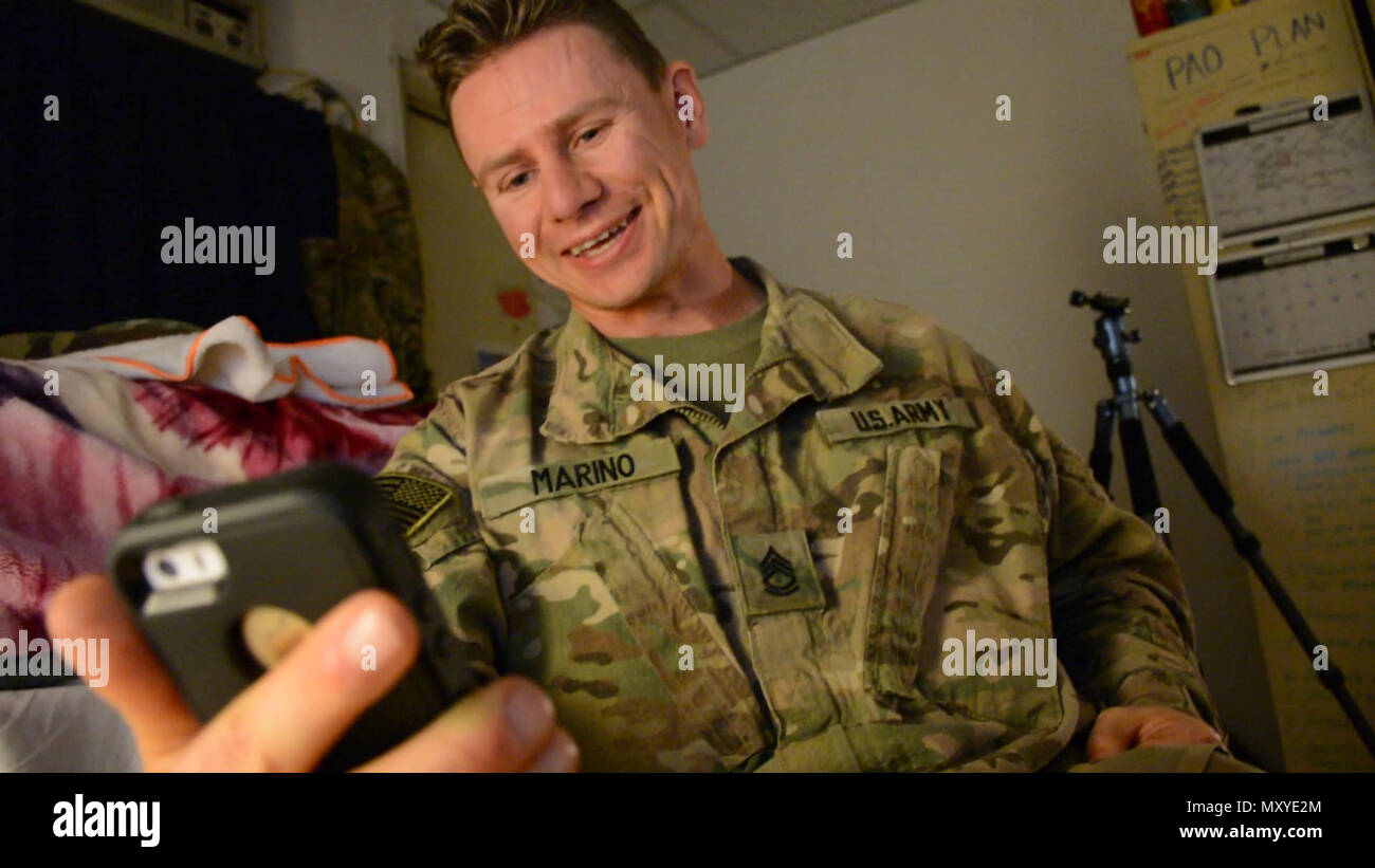 Kuwait-A private moment shared between a deployed father, Sgt. 1st ...