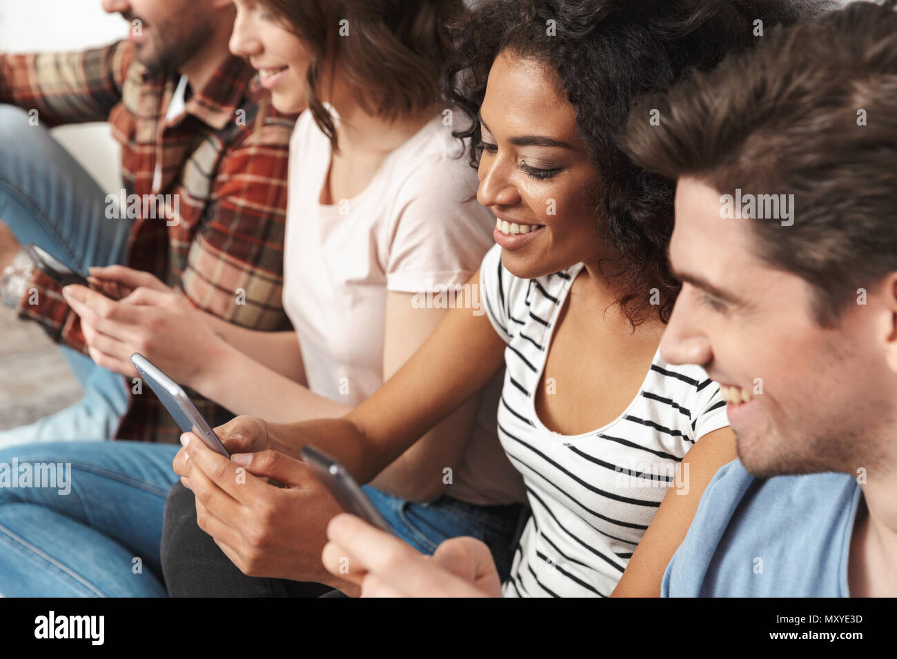 Group friends cellphones african hi-res stock photography and images ...