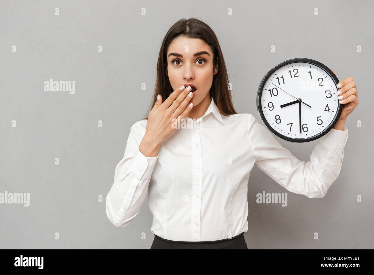 Photo of confused office woman in white shirt and black skirt holding ...