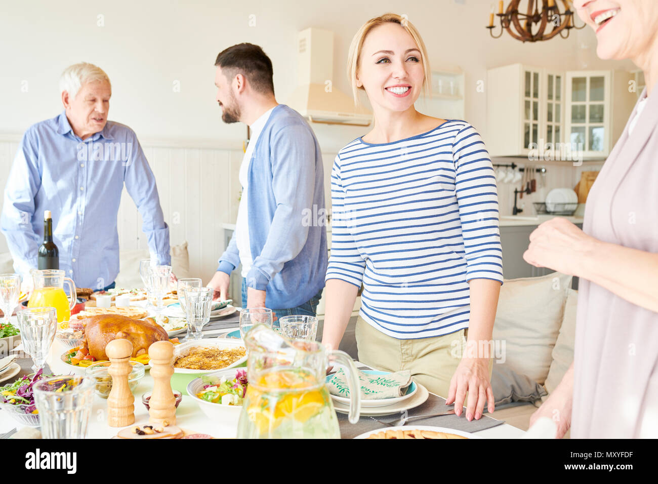 Portrait of happy two generation family preparing dinner together ...