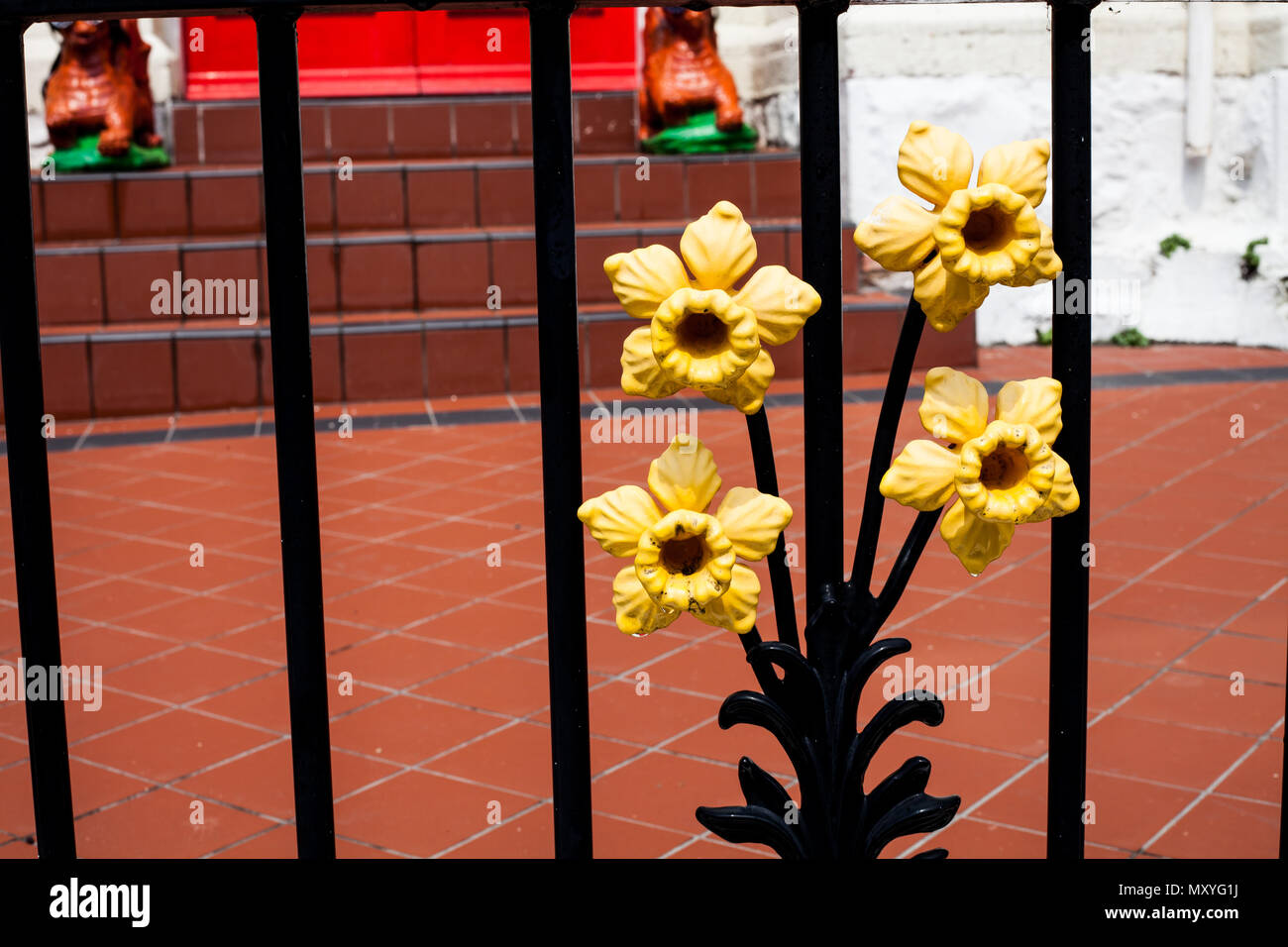 Forged yellow items on gate. Decorative fragment in the form of a ...