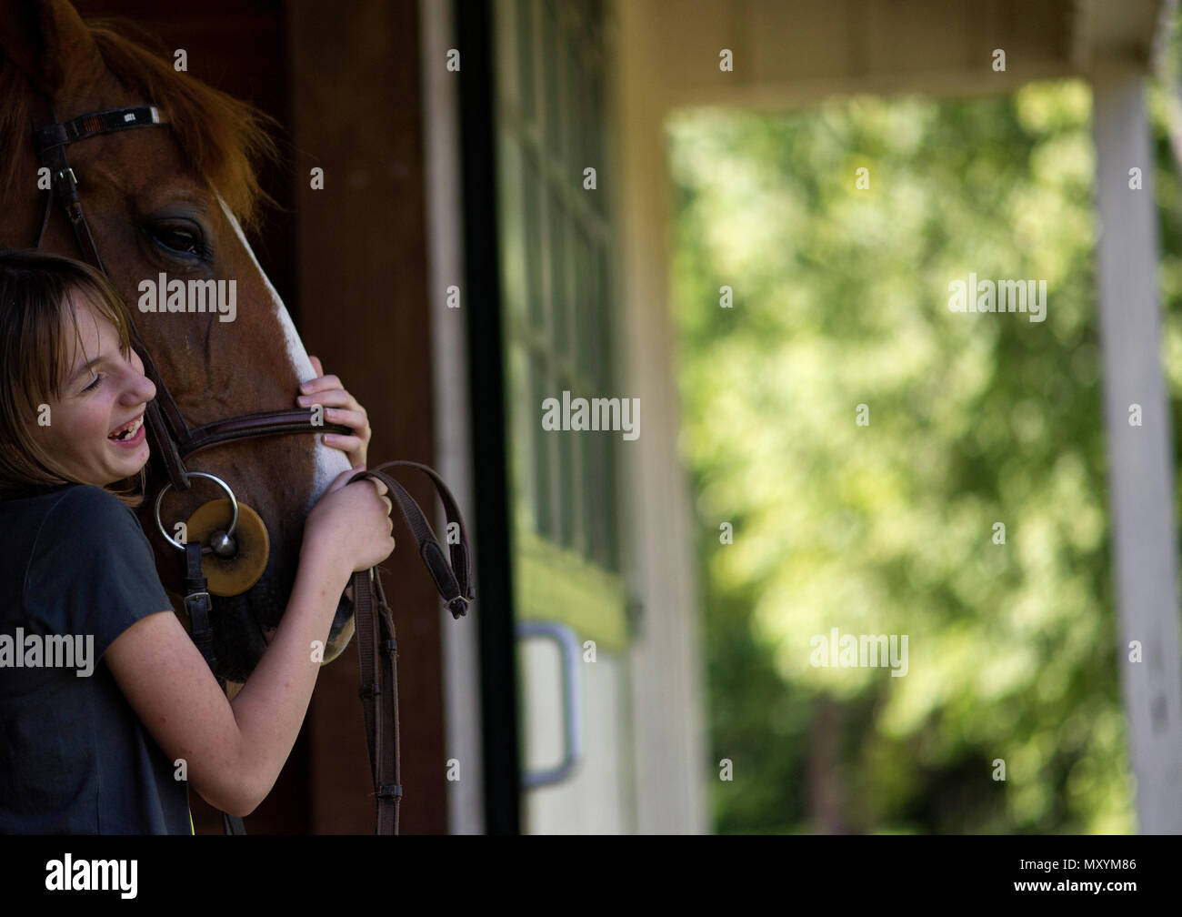 UNITED STATES: June 4, 2018: An equestrian get her horse ready to ride ...