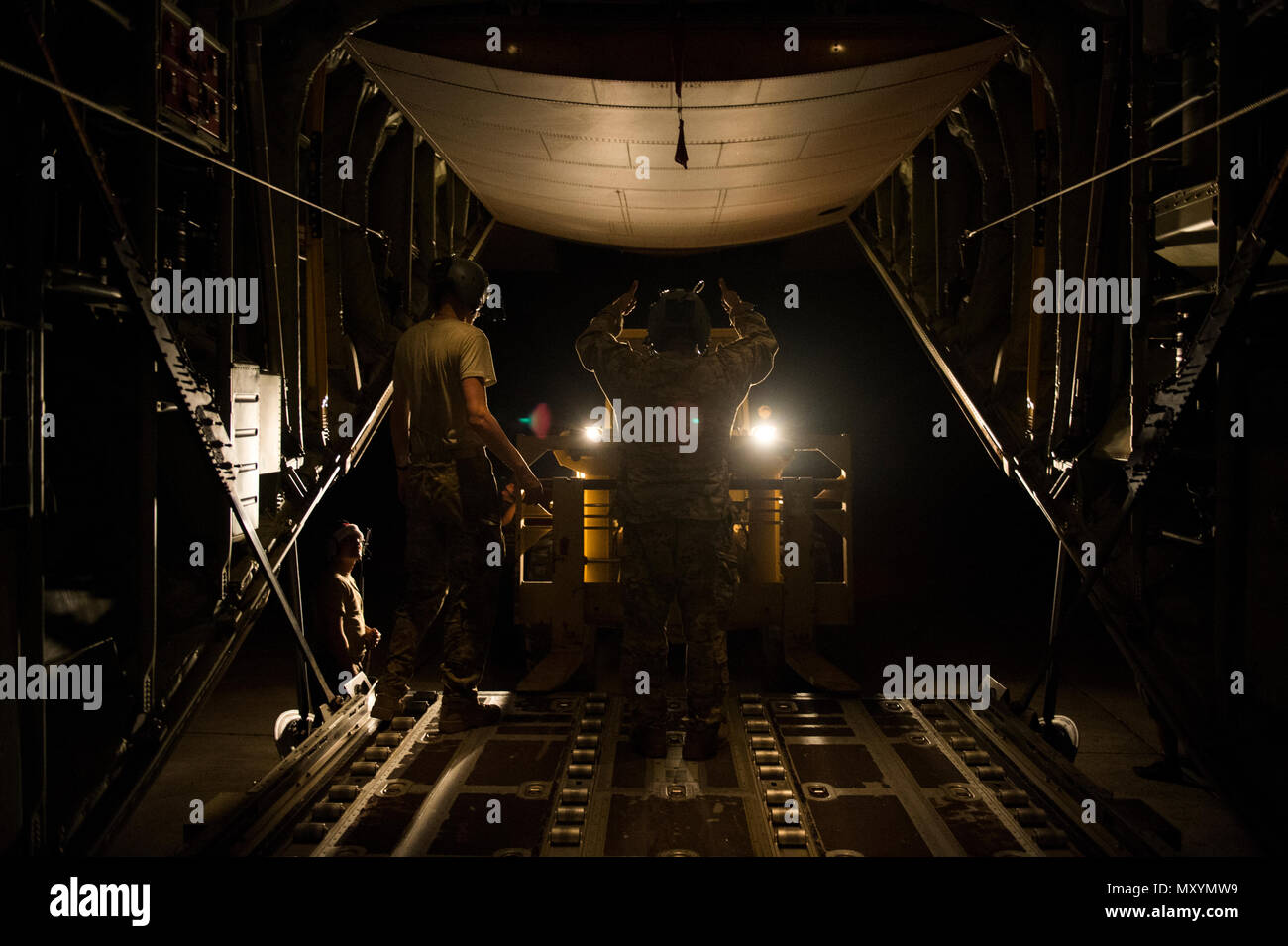 U.S. Air Force Master Sgt. Casey Holihan, a loadmaster assigned to the ...