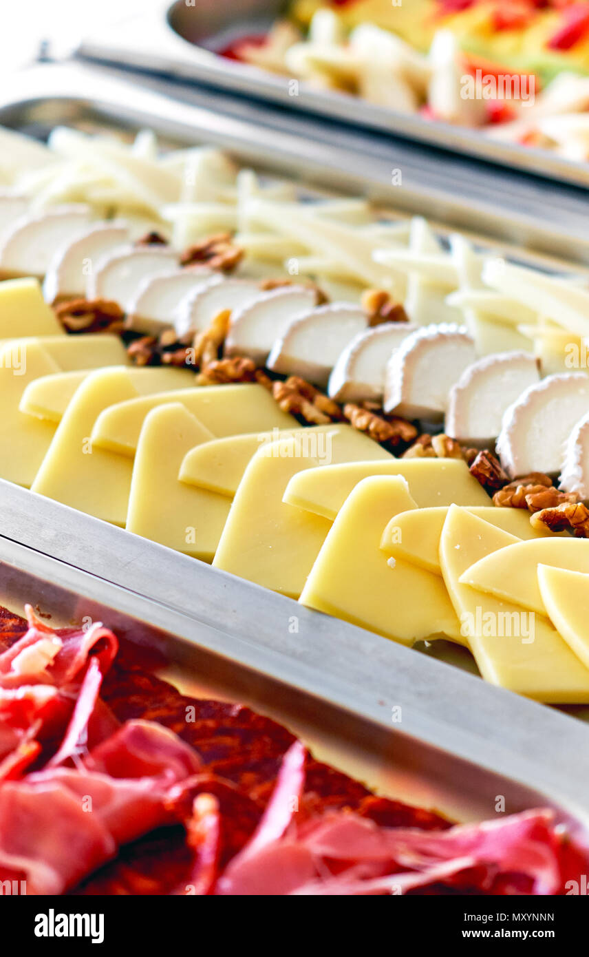 Buffet trays with a various delicious appetizers close-up. Breakfast in ...