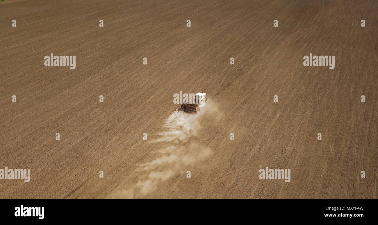 View from above of Tractor works in a field and plowing Stock Photo - Alamy