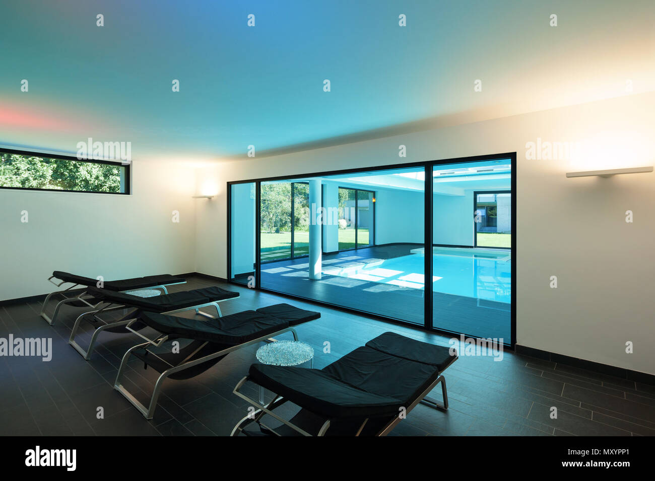 indoor swimming pool of a modern house with spa, room with sunbeds ...
