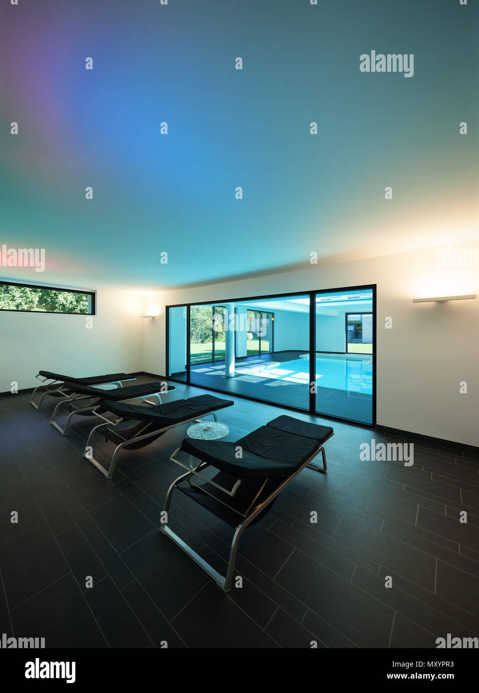 indoor swimming pool of a modern house with spa, room with sunbeds ...