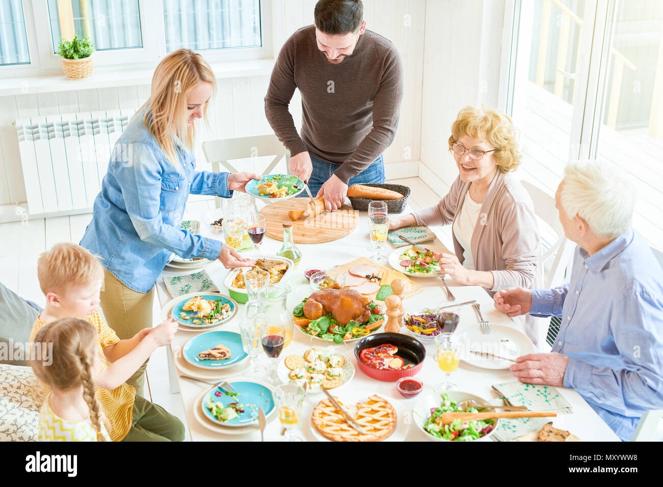 High angle portrait of big happy family enjoying dinner together ...
