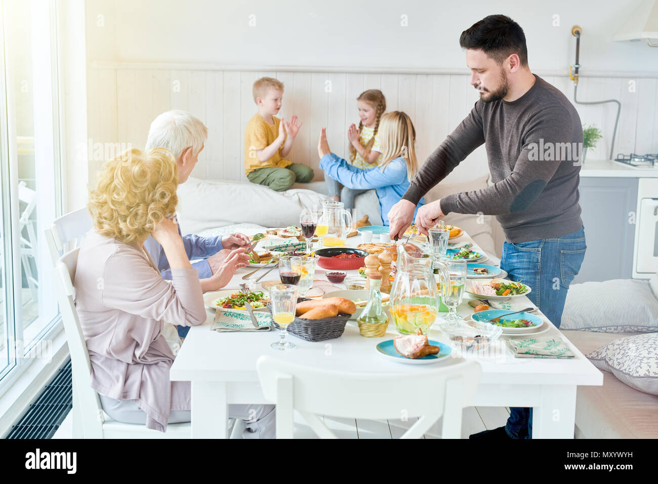 Portrait of happy family enjoying dinner together sitting in dining ...