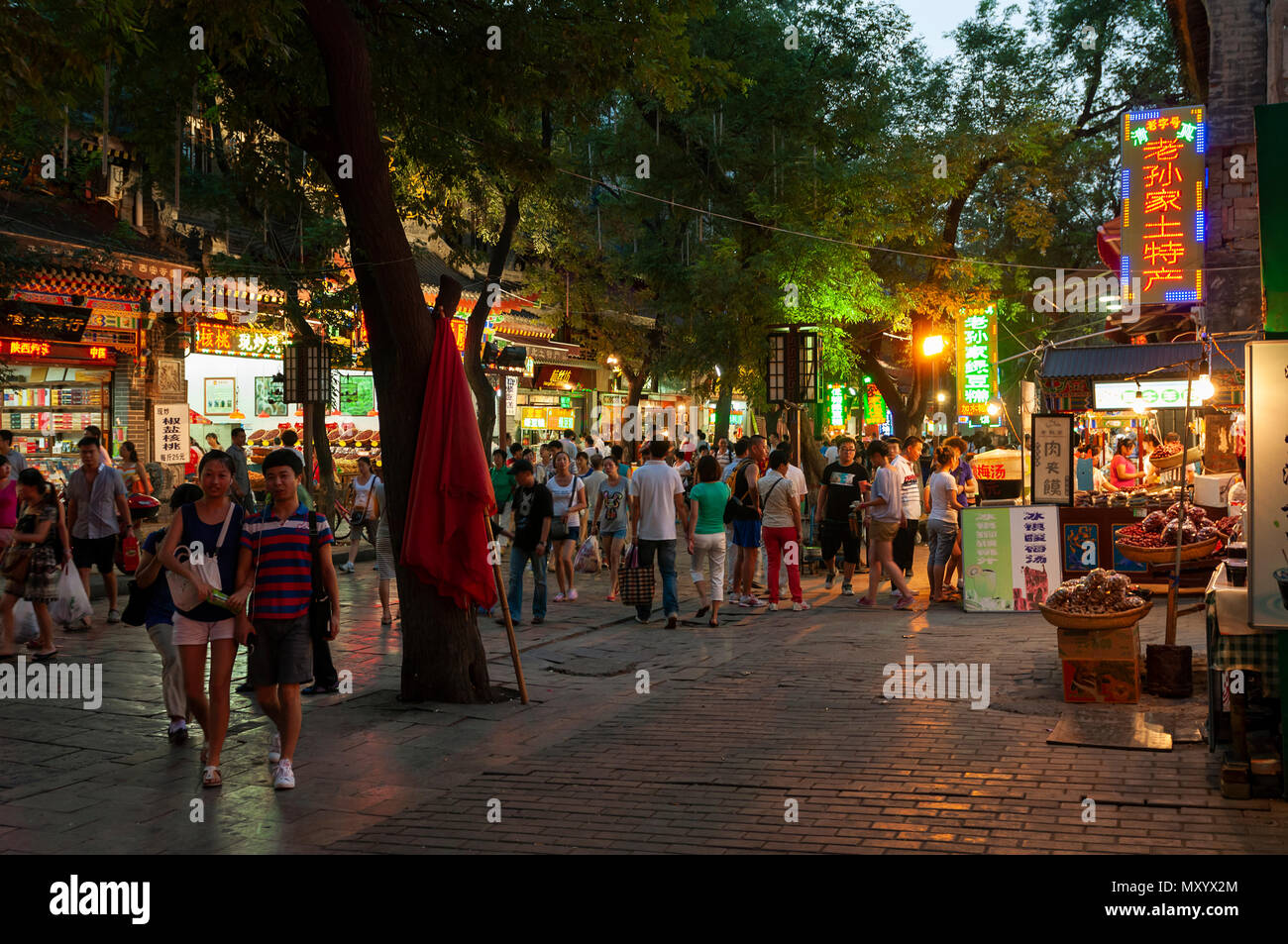 Xian, China - August 6, 2012: People walking in a street of the Muslim ...