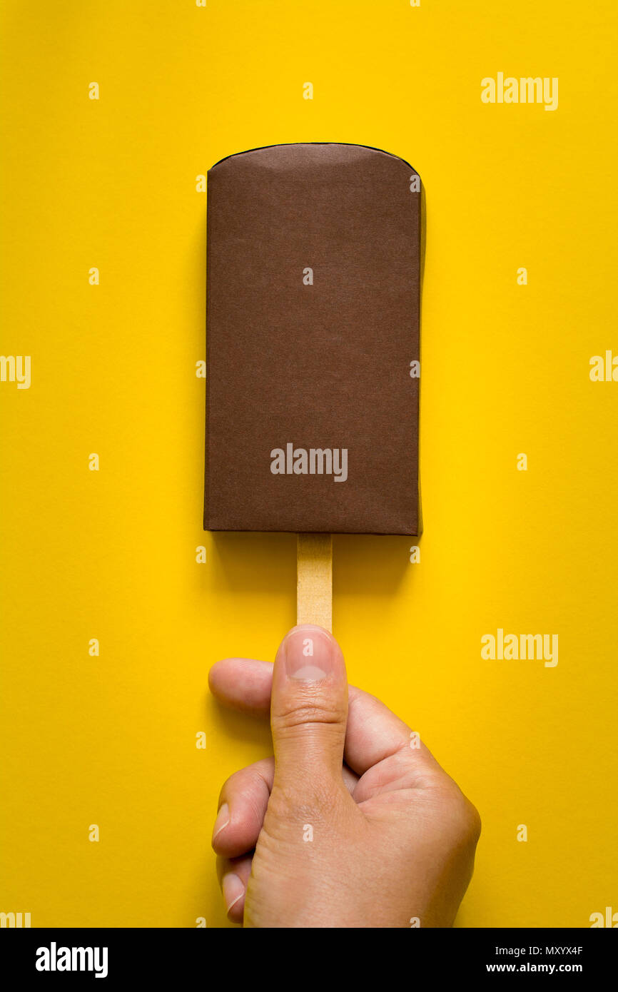 Summer holiday or non-organic food concept. Woman hand holding paper ...