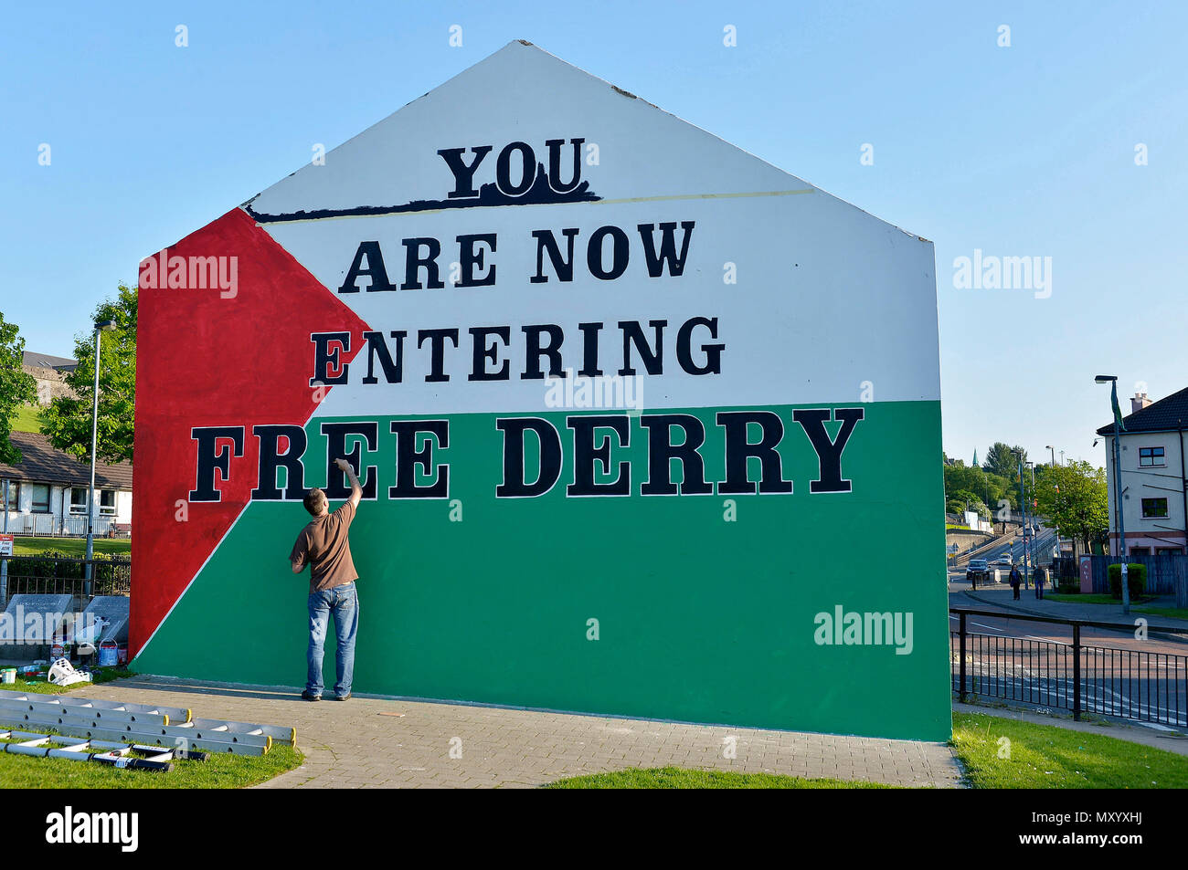 Local artist Jim Collins painting a Palestinian flag on the iconic Free ...