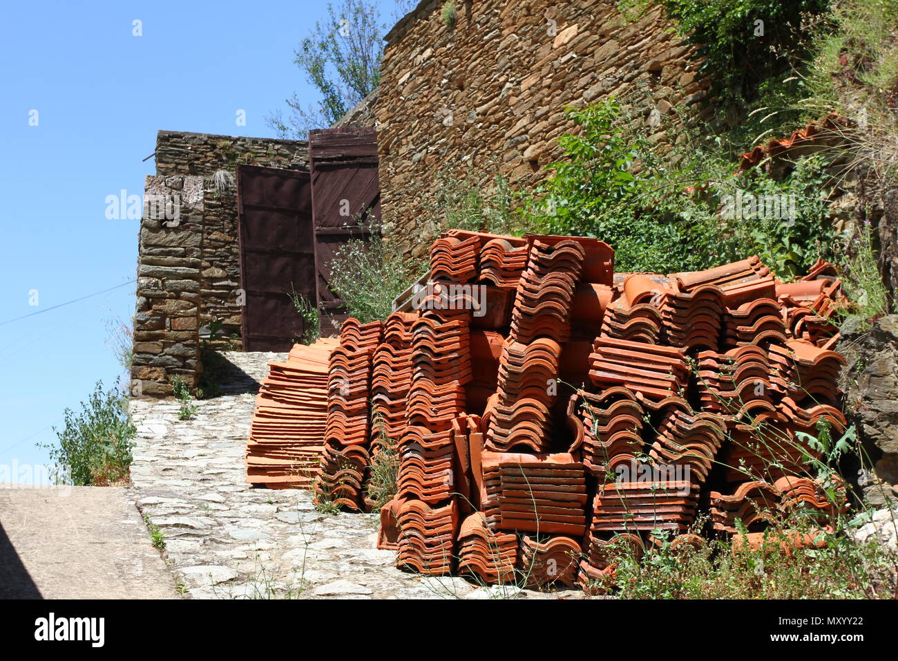Pile of clay roof tiles. Construction material for house building. Side ...