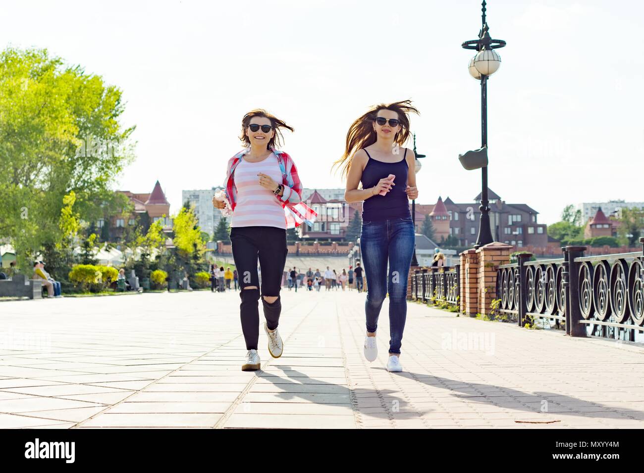 Women running along the road in the park. Urban background Stock Photo - Alamy