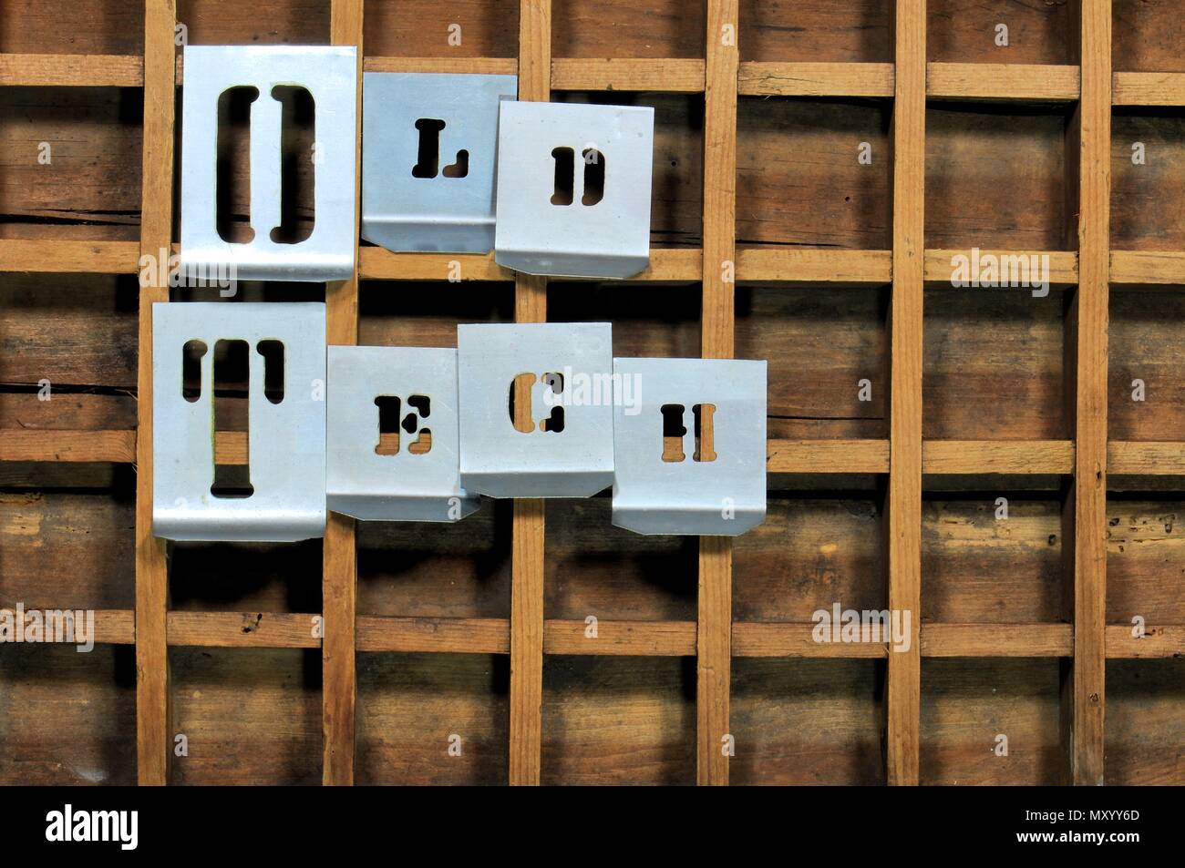 Word "OLD TECH" with stencils on old typefaces wooden container Stock ...