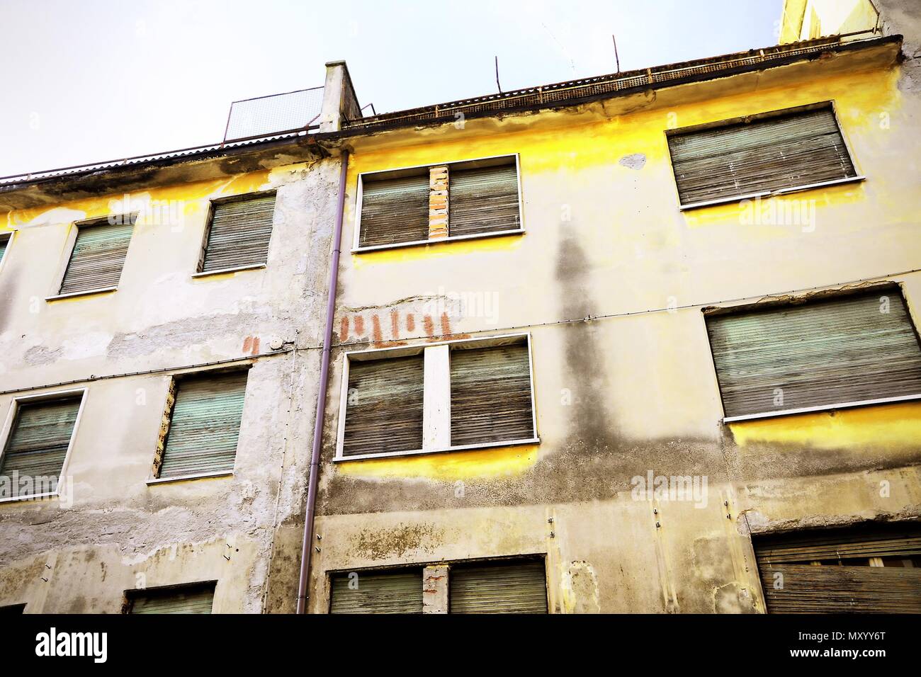 Vintage image of old and damaged facade of uninhabited building. Years ...
