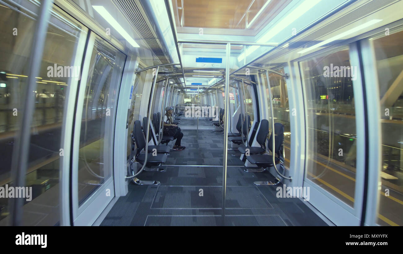 Monorail with train at Doha International Airport, Qatar. Train on the ...