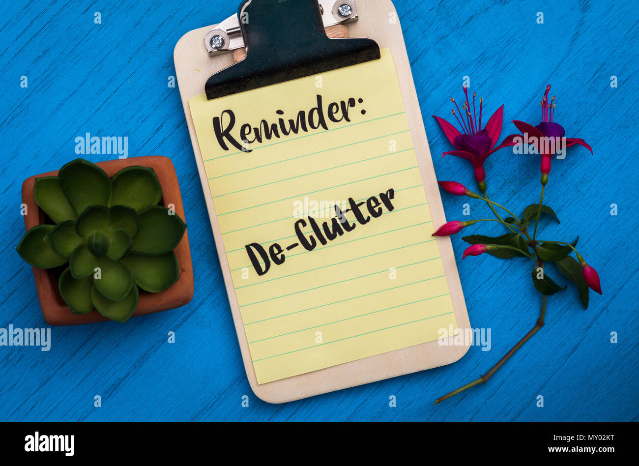 Reminder to De-Clutter still life motivational concept on clipboard and ...