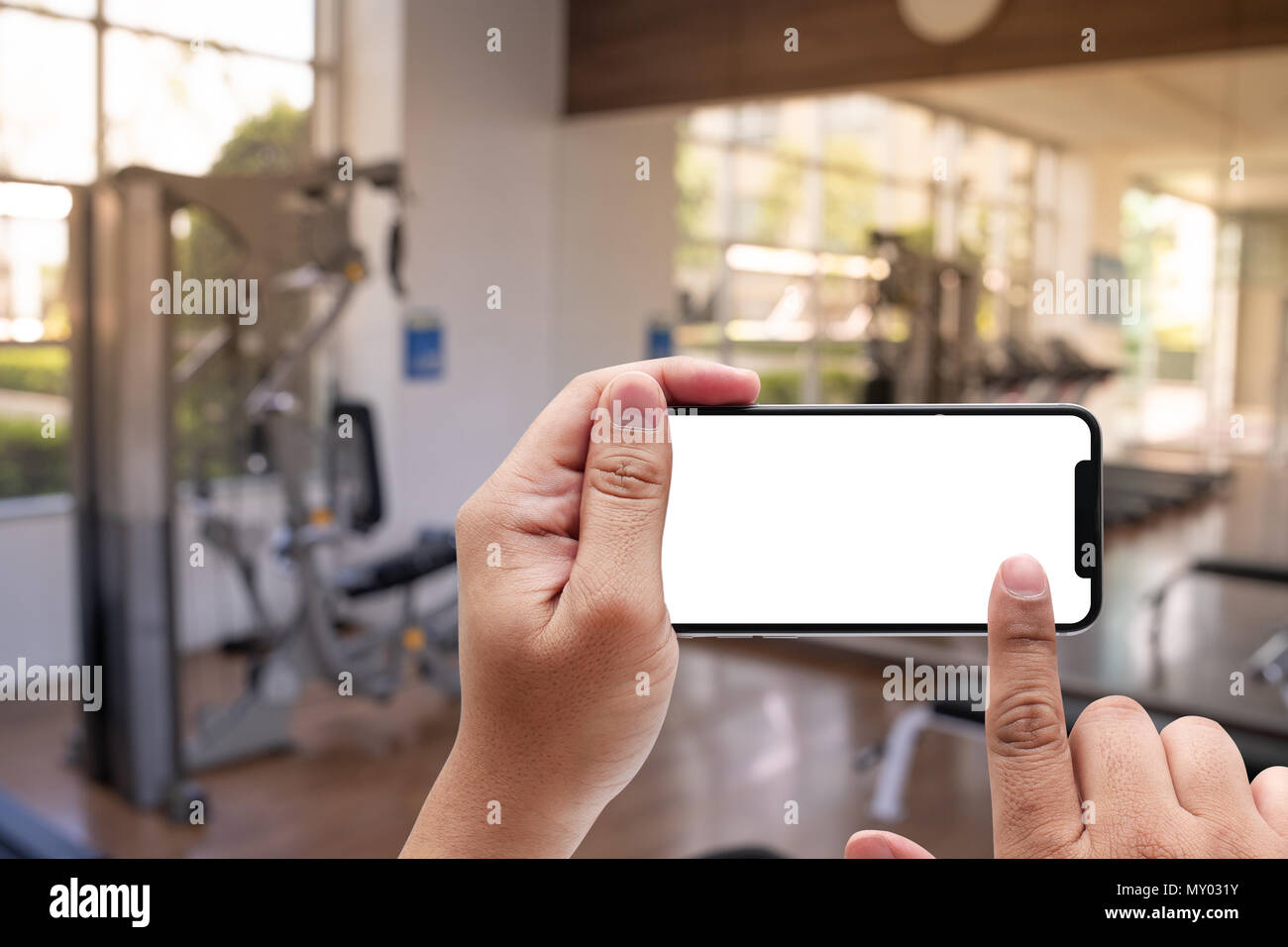 Young man Hand holding smartphone in gym to fitness phone fitness ...