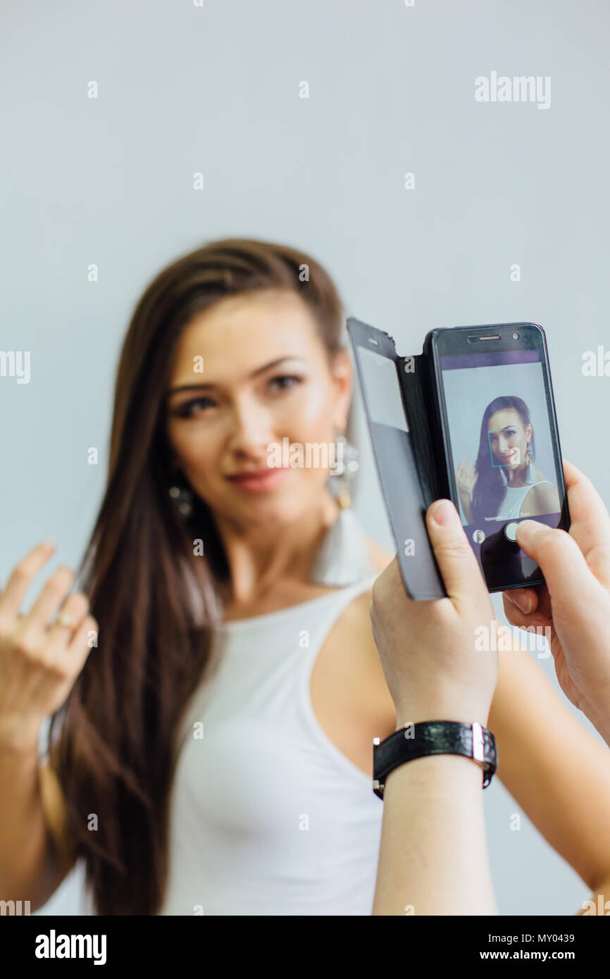 Beautiful young woman posing infront of mobile phone camera Stock Photo ...