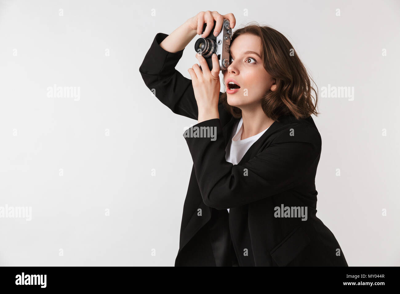Image of emotional young woman photographer standing isolated holding ...