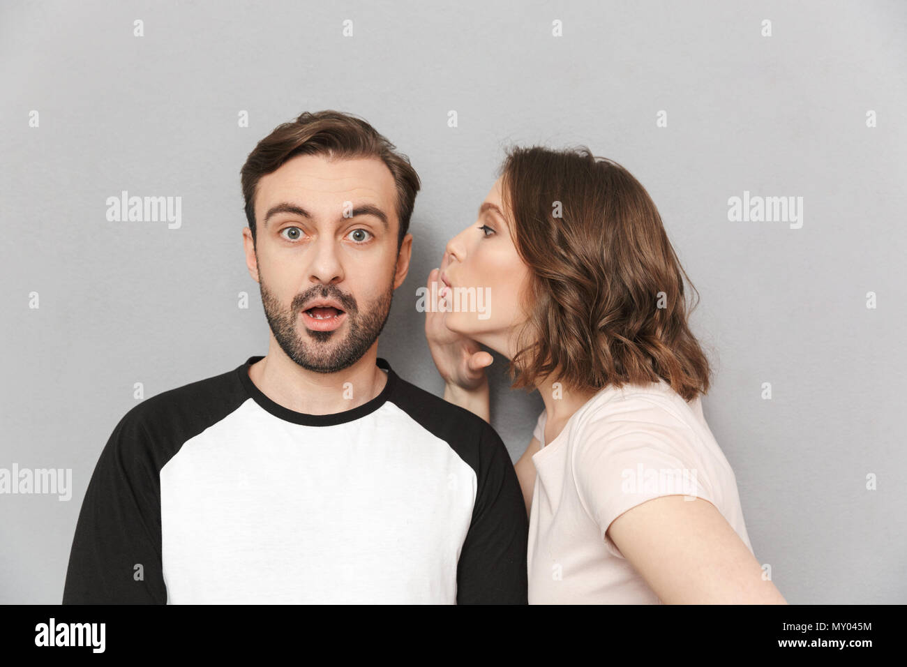 Image of emotional couple friends standing isolated over grey wall ...