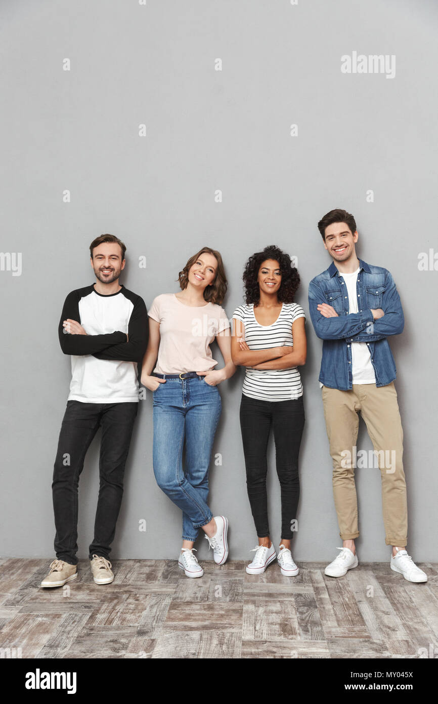 Image of happy group of friends standing isolated over grey wall ...