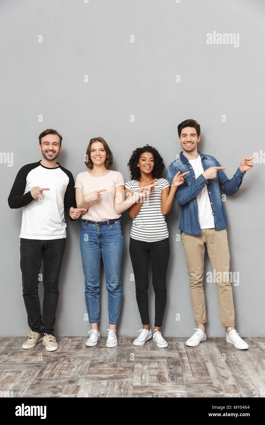Image of emotional excited group of friends standing isolated over grey ...