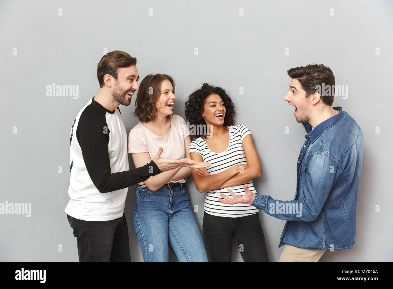 Image of emotional excited group of friends standing isolated over grey ...