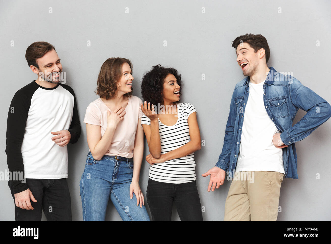 Image of emotional excited group of friends standing isolated over grey ...