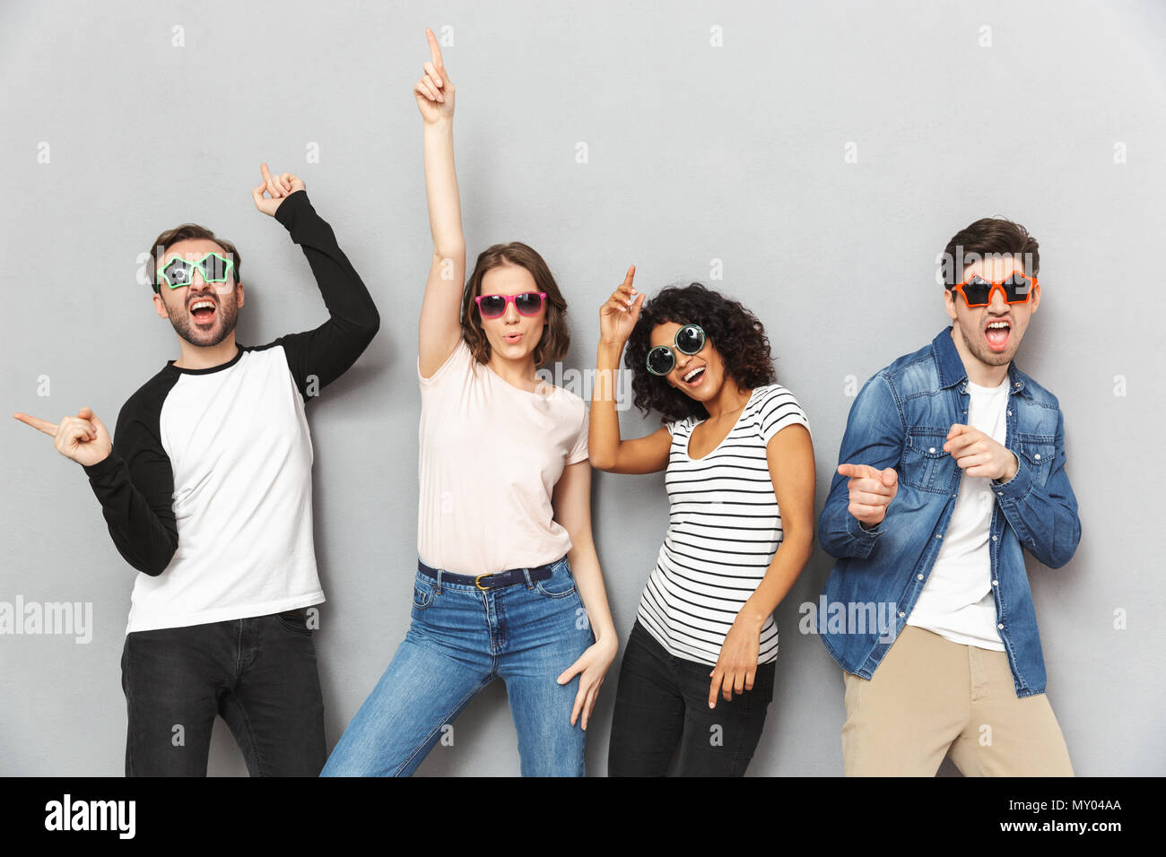 Image of happy group of friends standing isolated over grey wall ...
