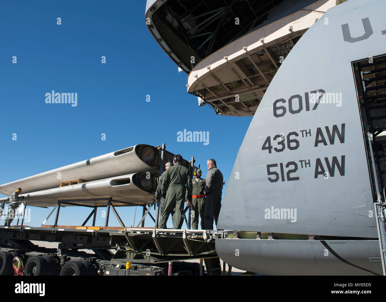 Loadmasters from the 709th Airlift Squadron prepare to load the wings ...