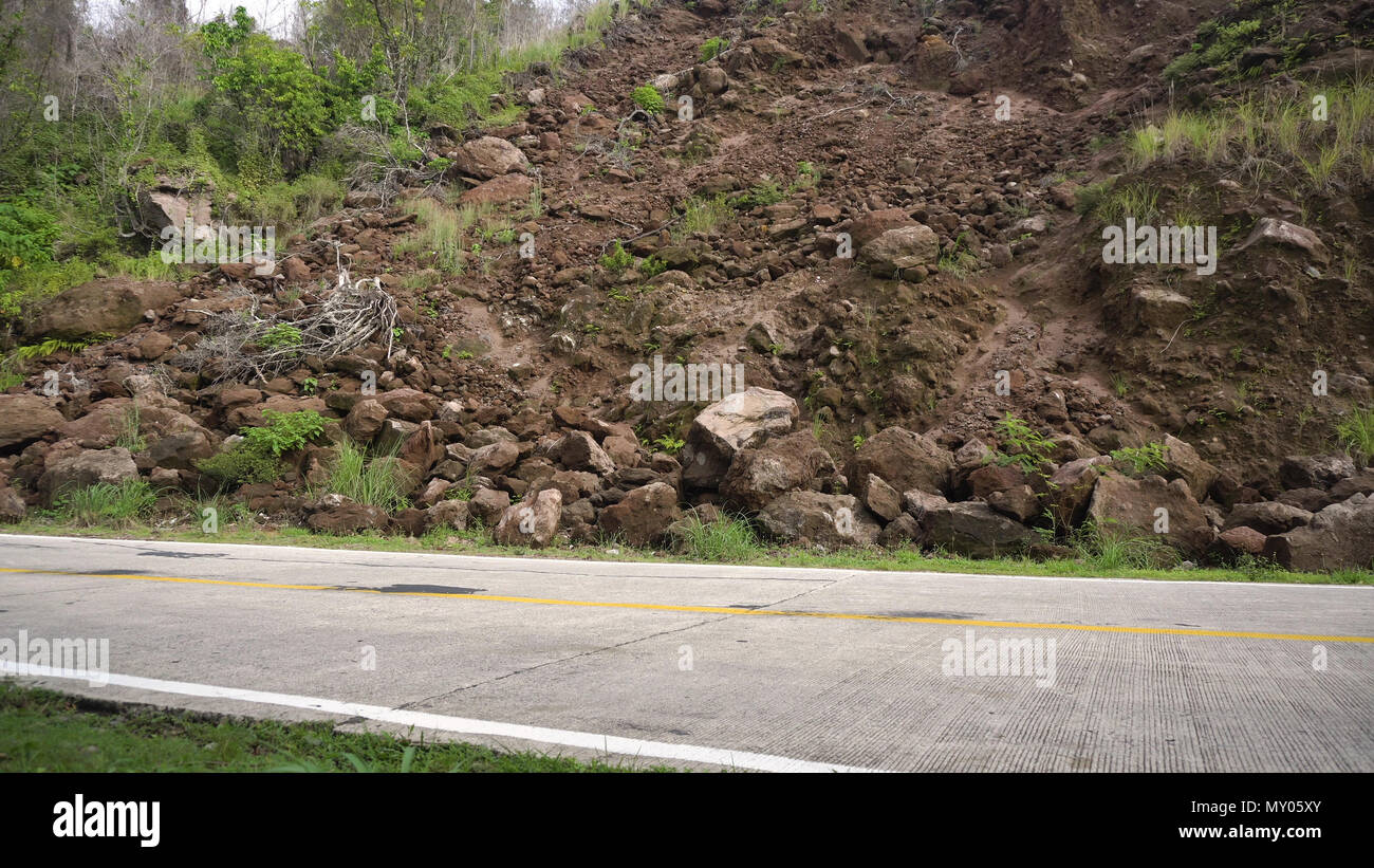 Landslides and rockfalls on the road in the mountains. Mud and rocks ...