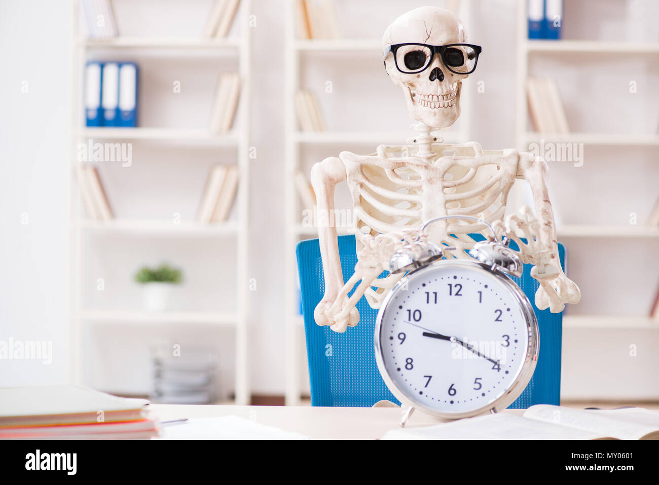 Skeleton businessman working in the office Stock Photo - Alamy