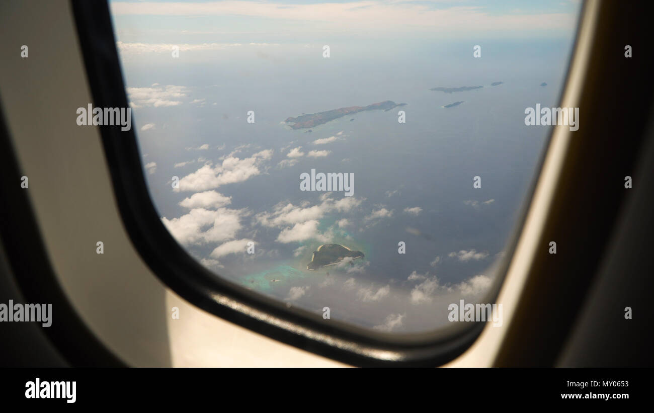 Wing of aeroplane over ocean island hi-res stock photography and images ...