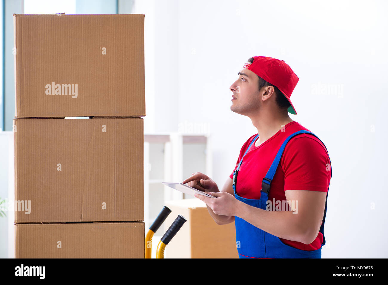 Contractor worker moving boxes during office move Stock Photo - Alamy