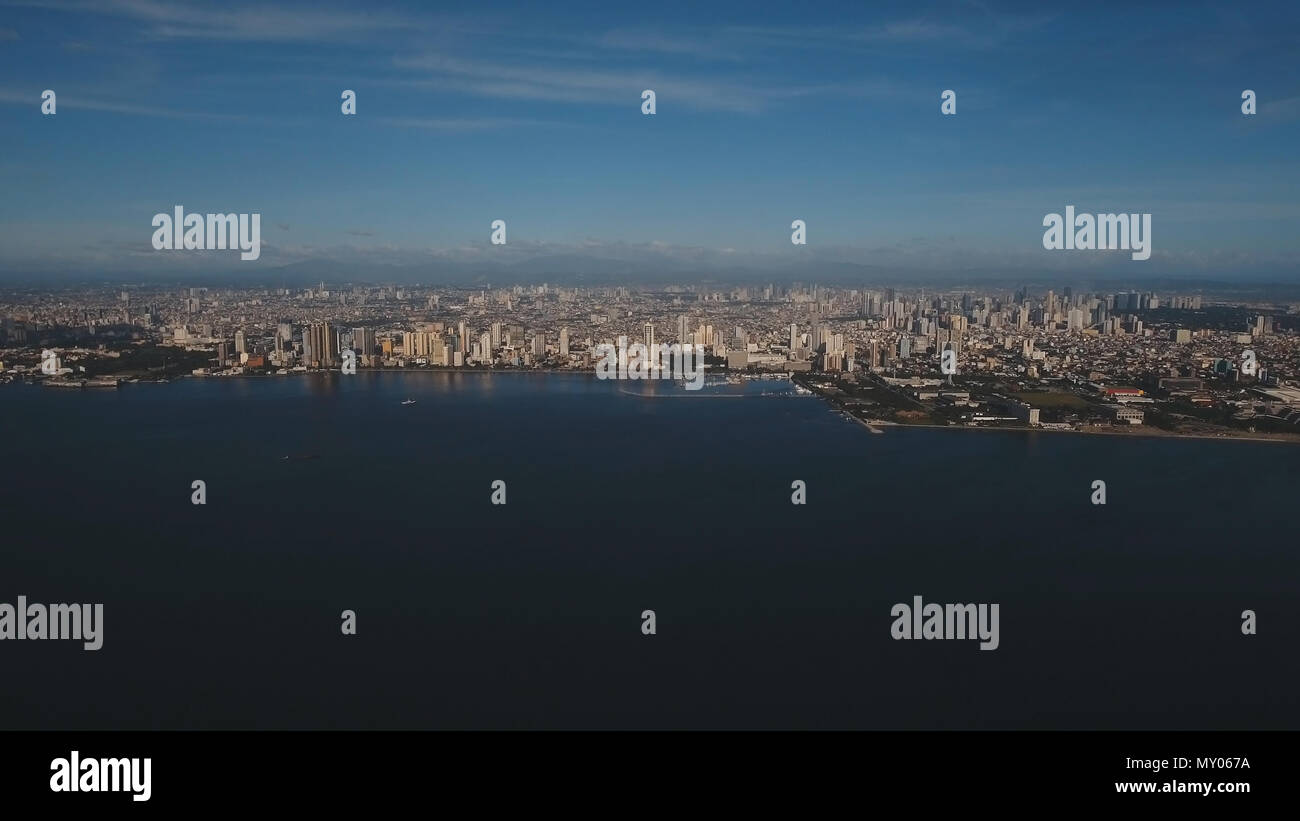 Aerial view skyline of Manila city at sunset. Fly over city with ...