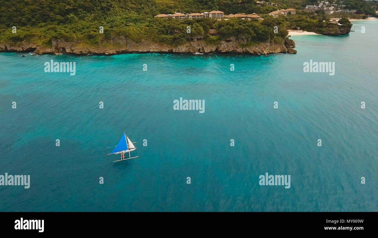 Sailing boat in blue, turquoise lagoon. Sailing ship yachts with blue ...