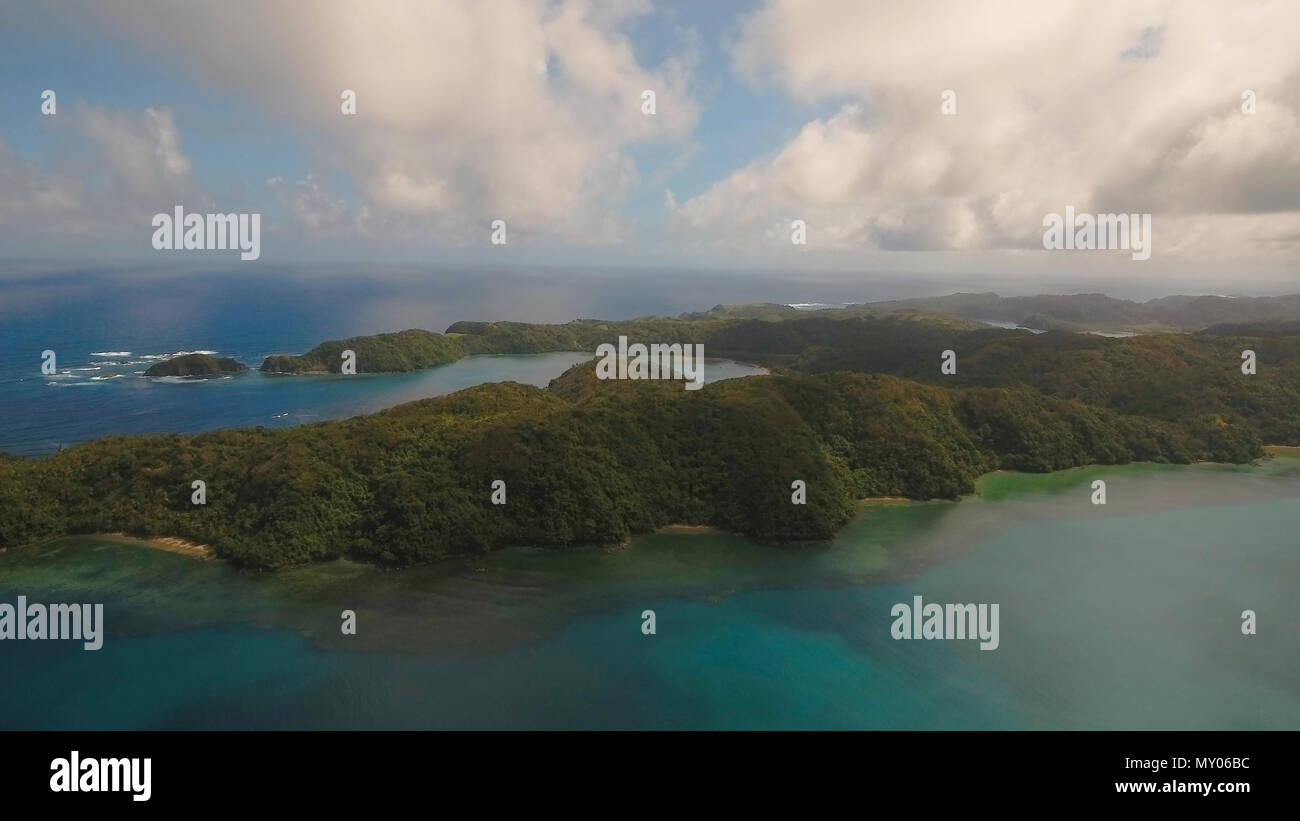 Aerial view:Tropical island with beach, mountains and the rainforest ...